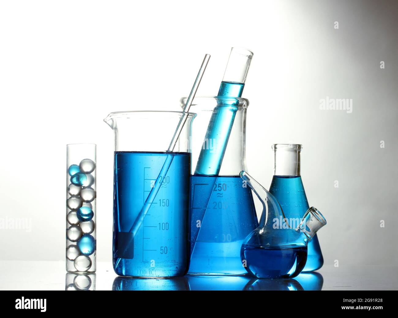 Test-tubes with blue liquid isolated on white Stock Photo - Alamy