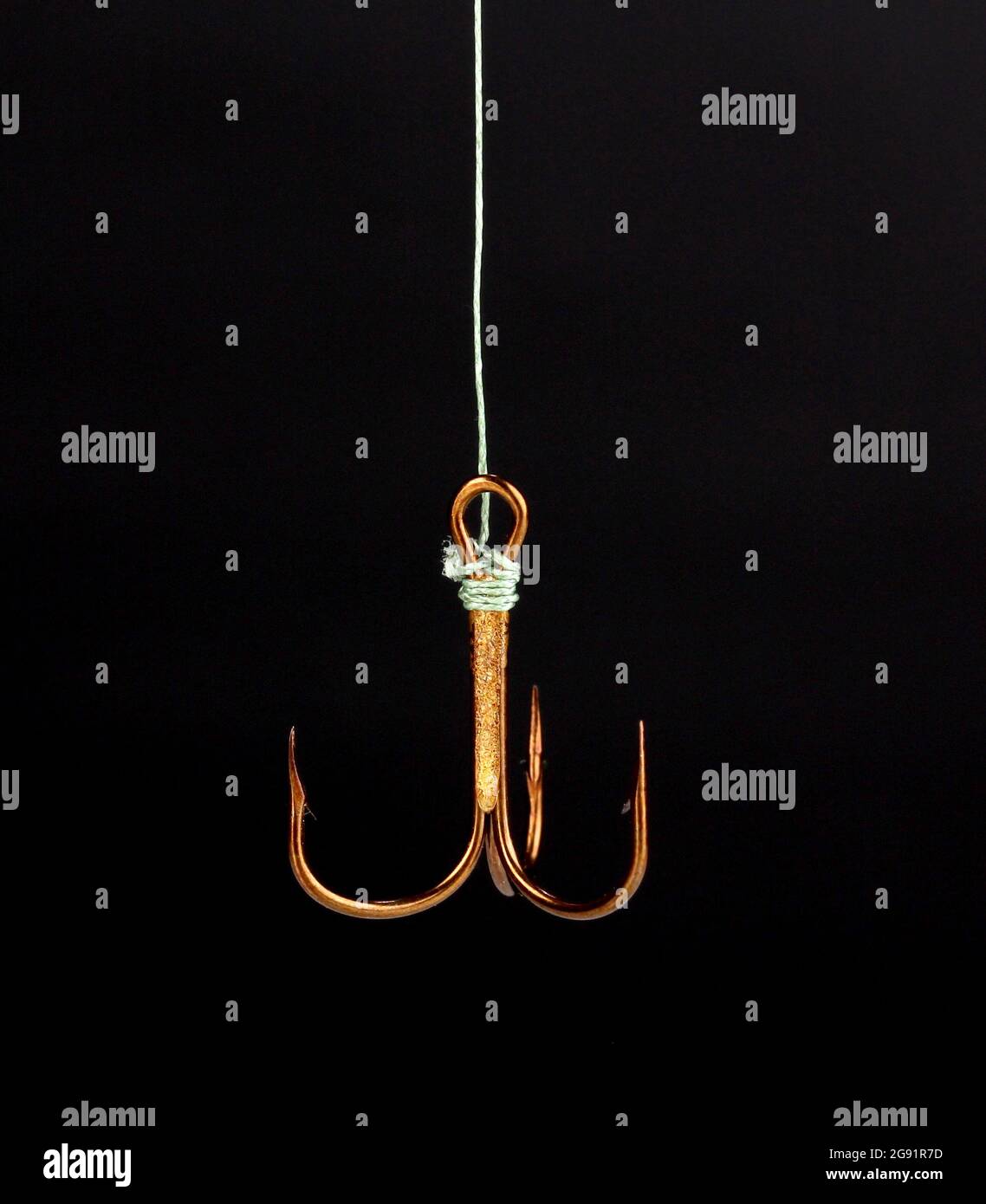 Treble fish hook isolated on black Stock Photo - Alamy