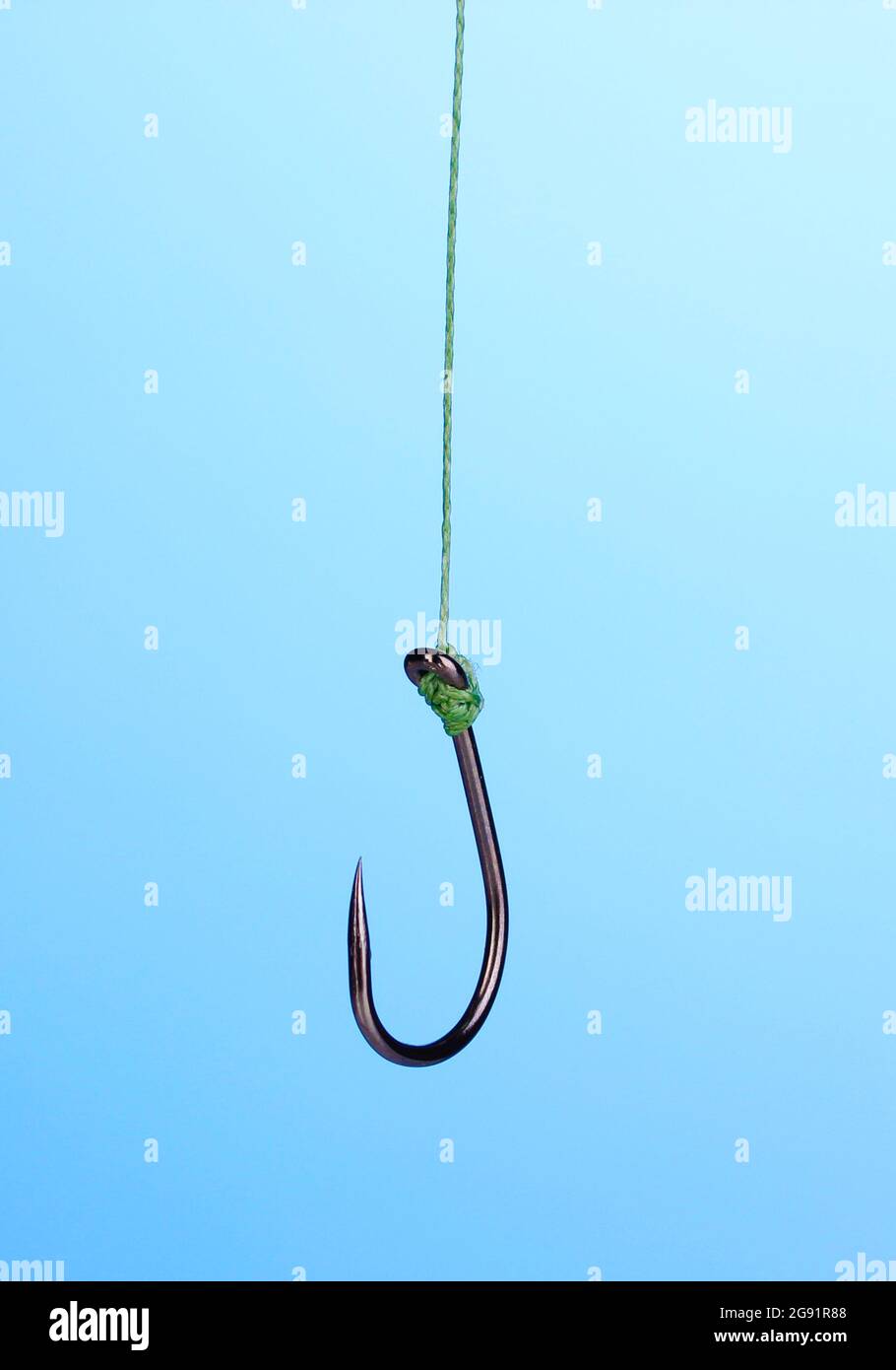 Single fish hook on blue background Stock Photo - Alamy