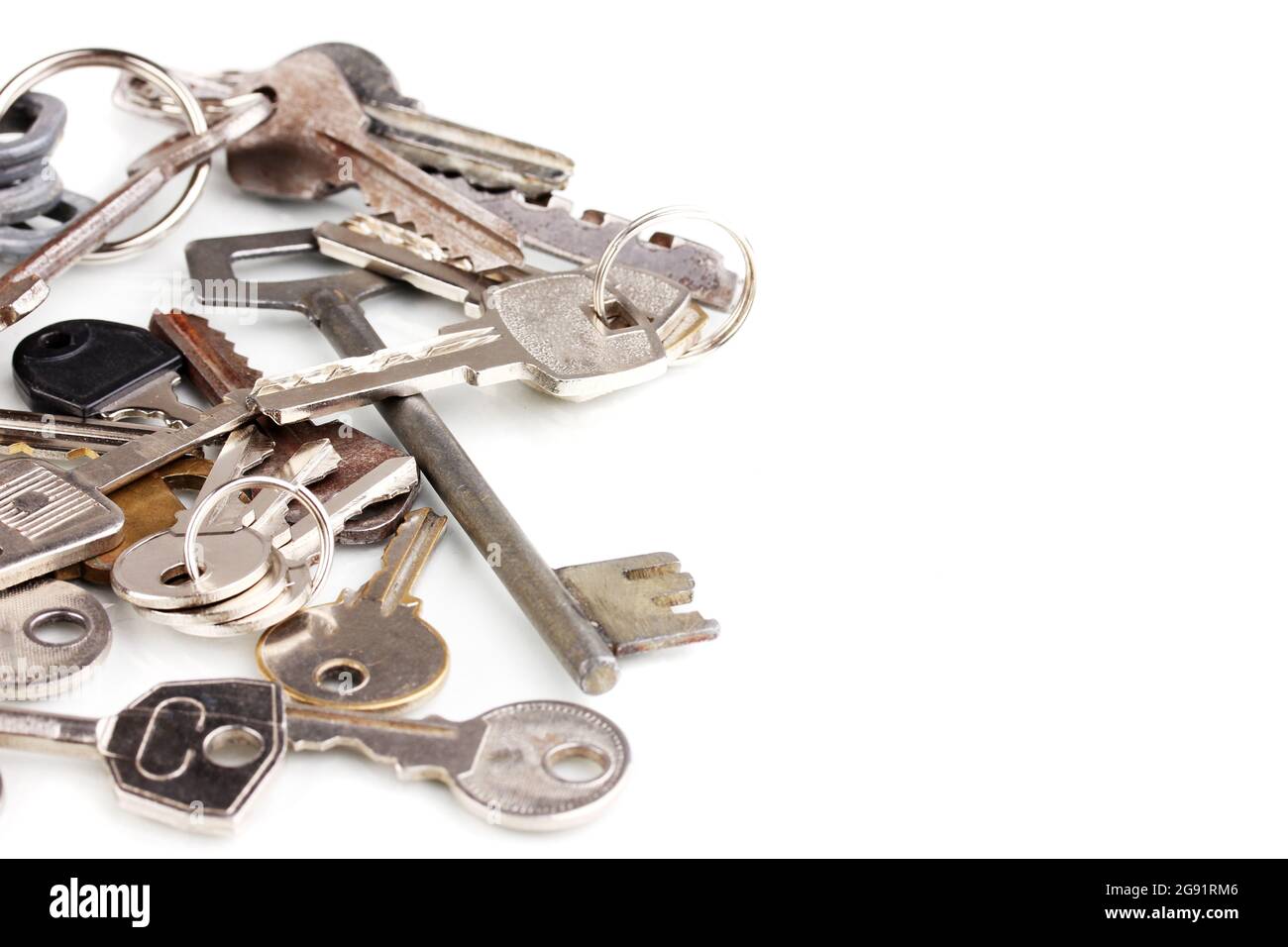 Lot of metal keys isolated on white Stock Photo - Alamy