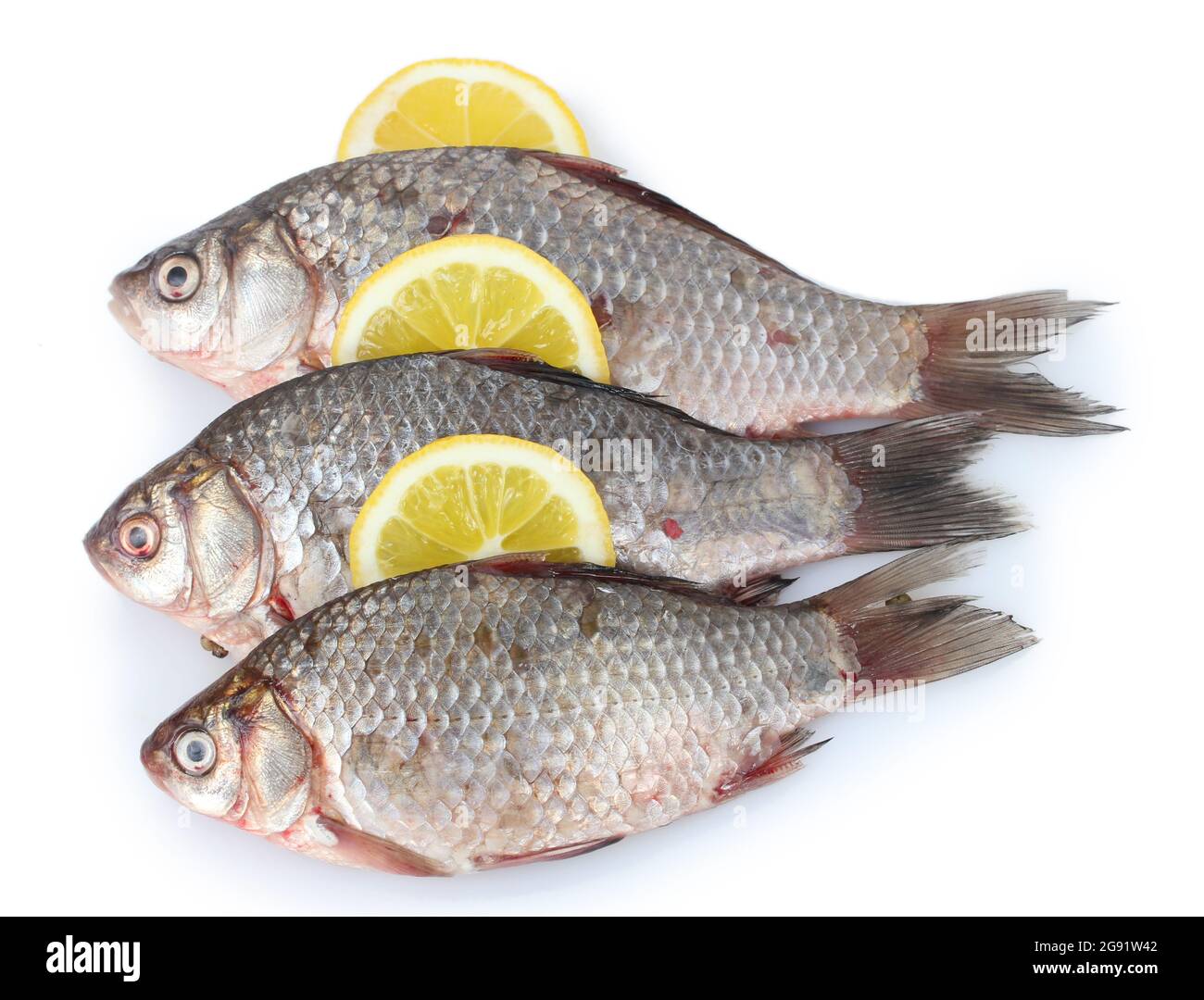 Fresh fishes with lemon isolated on white Stock Photo - Alamy