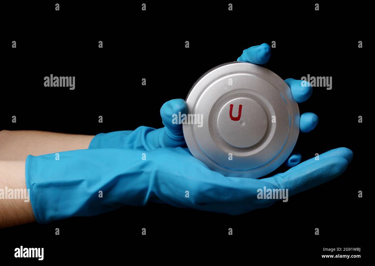 Uranium in hands isolated on black Stock Photo - Alamy