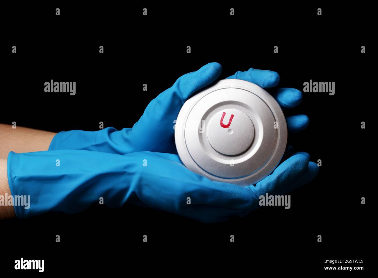 Uranium in hands isolated on black Stock Photo - Alamy