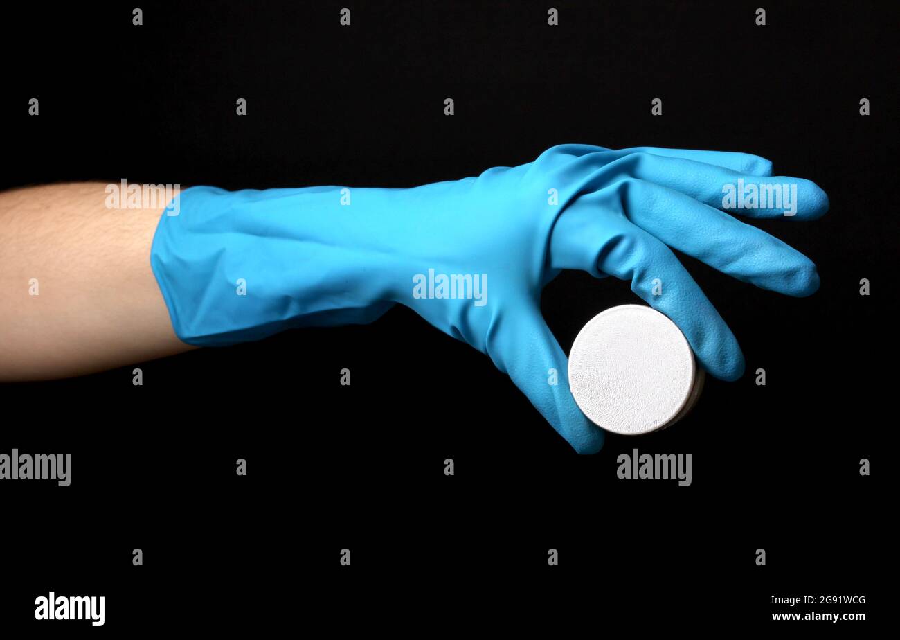 Uranium in hand isolated on black Stock Photo - Alamy
