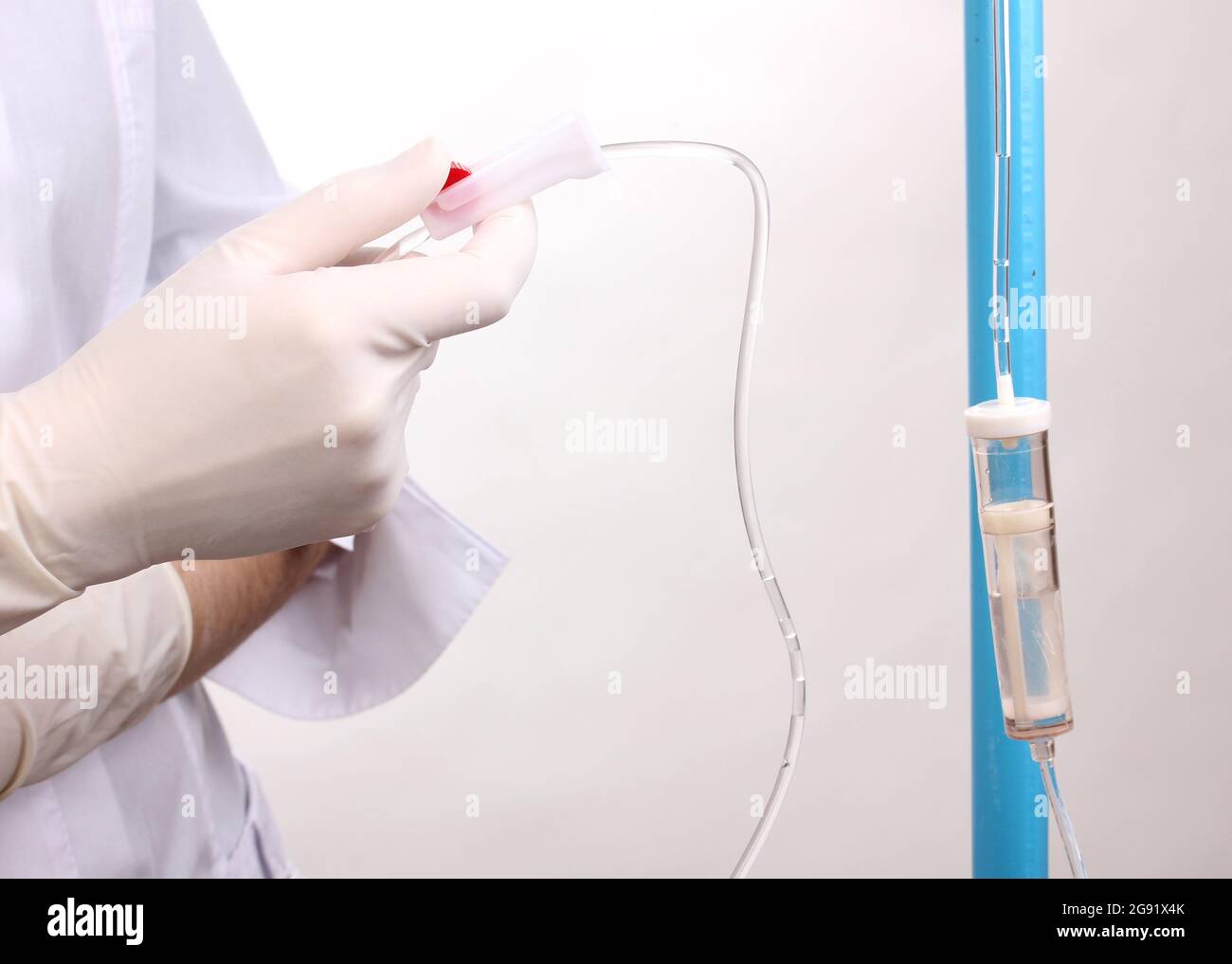 Nurse doing infusion isolated on white Stock Photo - Alamy