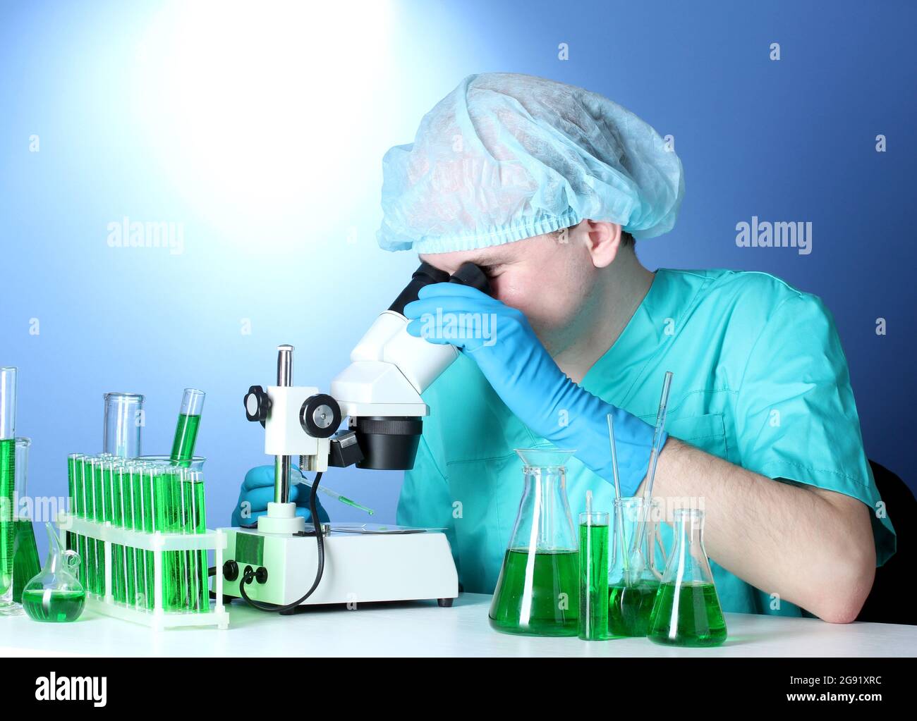 scientist looking at microscope in chemistry laboratory Stock Photo - Alamy