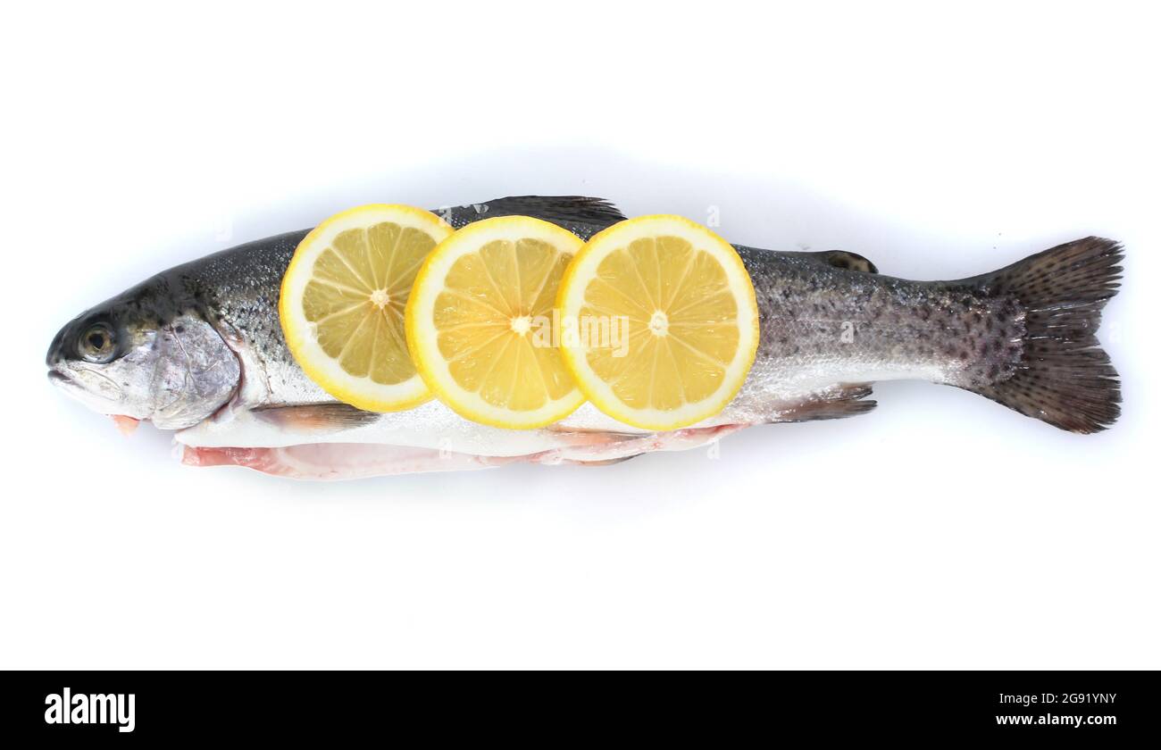 Fresh fish with lemon isolated on white Stock Photo - Alamy