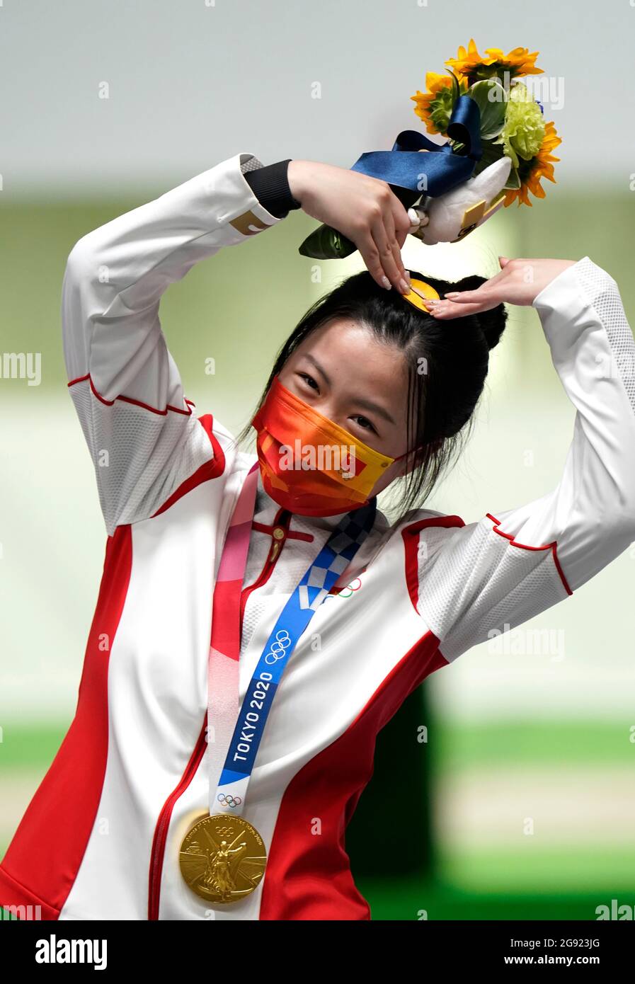 China's Qian Yang celebrates with her gold medal after winning the 10m ...