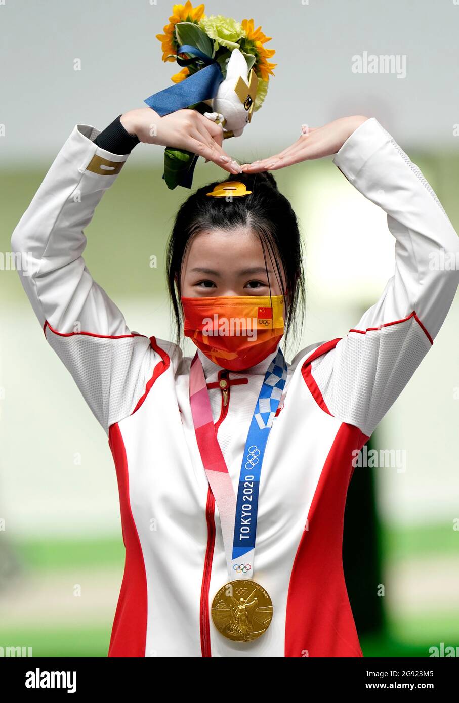 China's Qian Yang celebrates with her gold medal after winning the 10m ...
