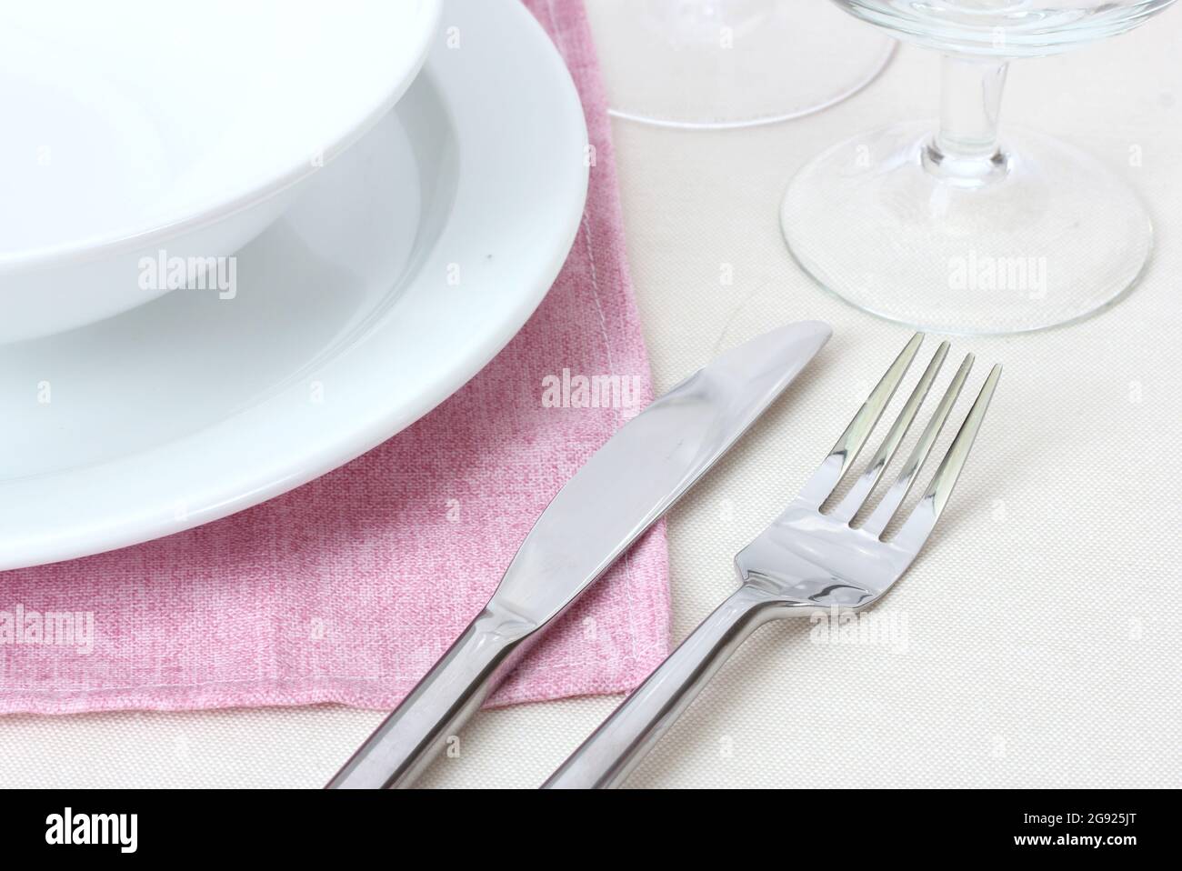 Table setting with fork, knife, plates and napkin Stock Photo - Alamy