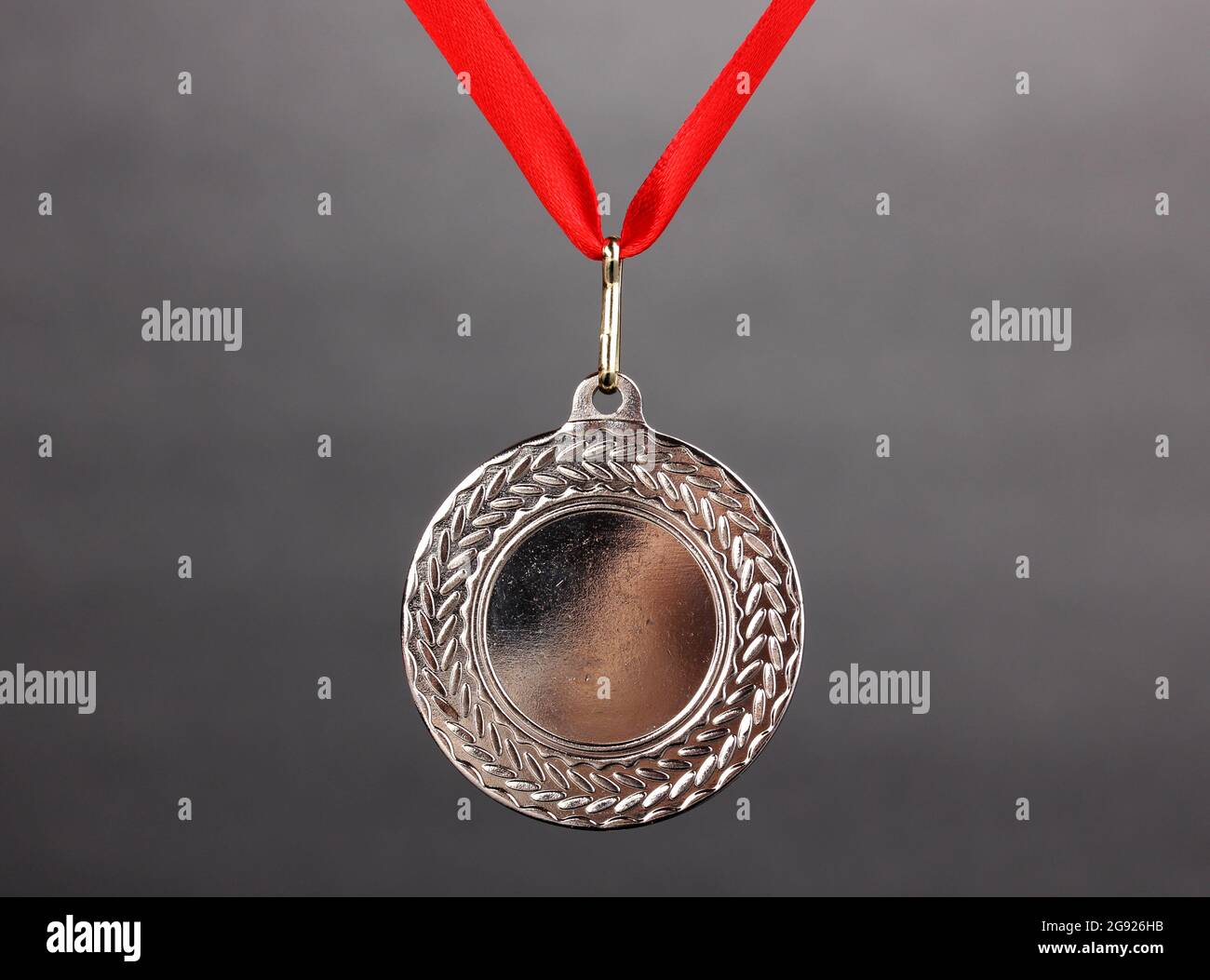 Silver medal on grey background Stock Photo - Alamy