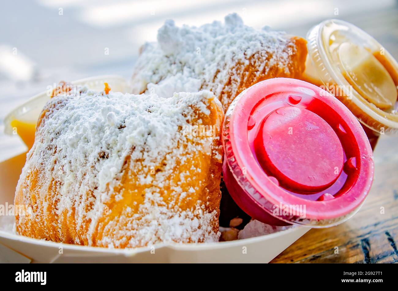 Beignets are served with raspberry and buttercream dipping syrup at Mo ...