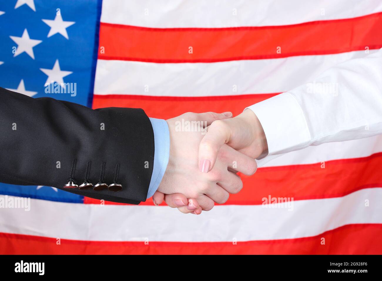 Business handshake on american flag background Stock Photo - Alamy