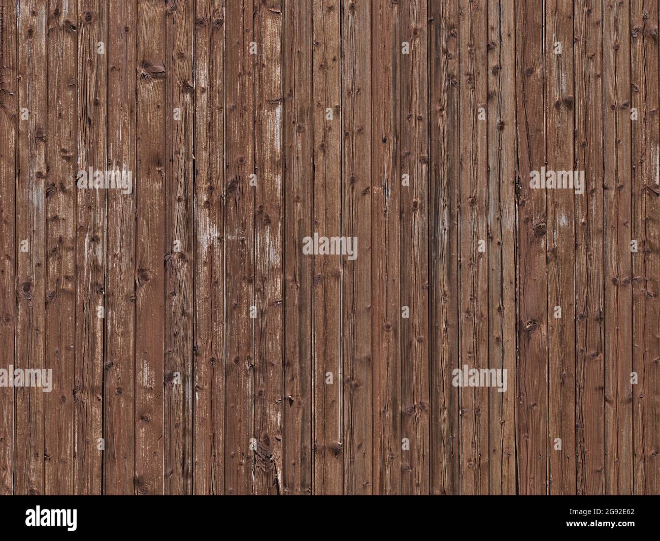 Closeup view of weathered wooden wall of a shed constructed of brown ...