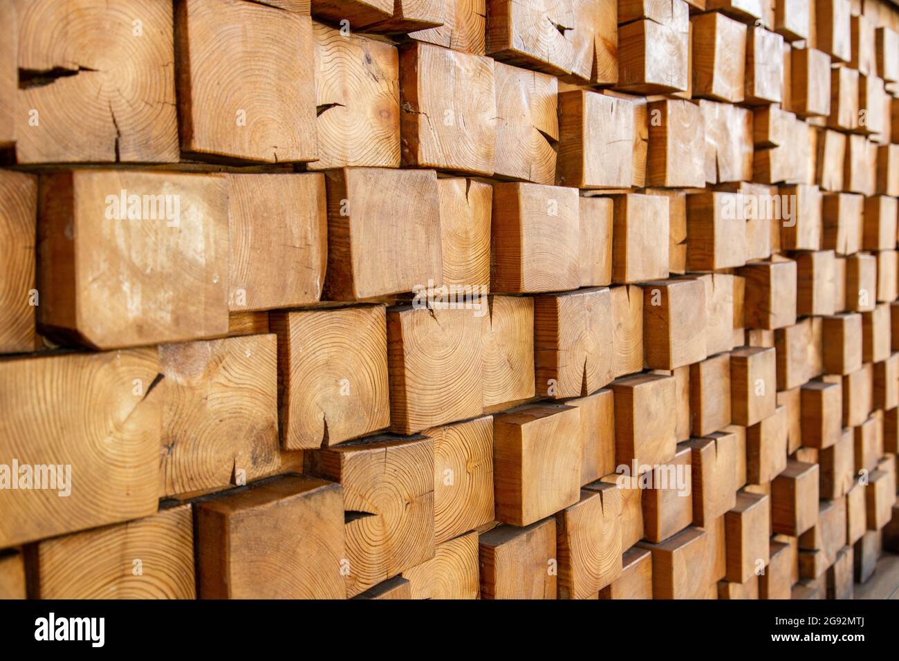 Wooden, textured wall lined with wooden cubes, longitudinal cuts of a ...