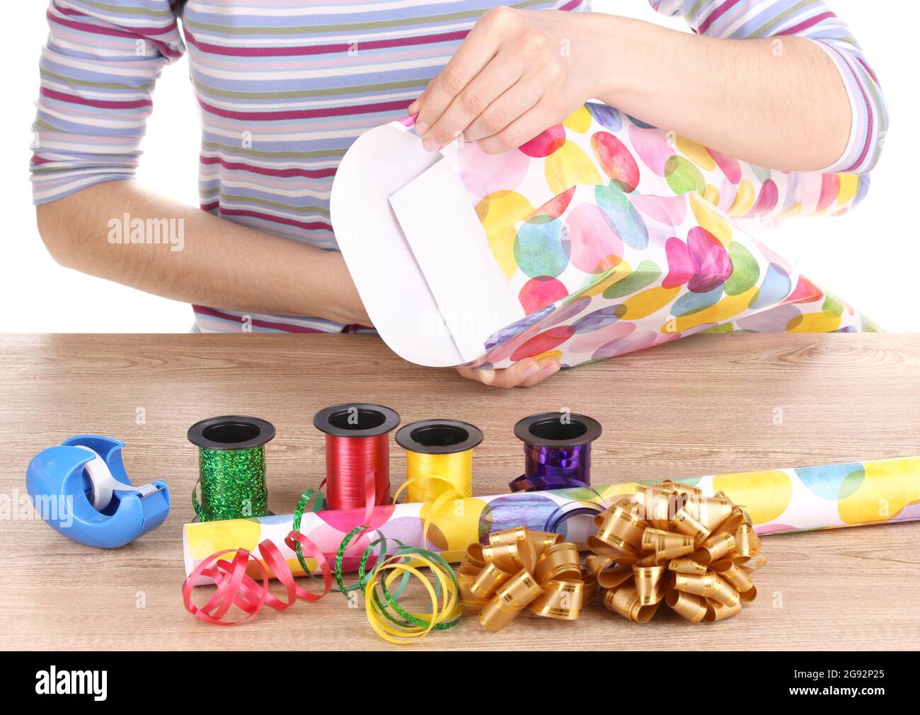 Wrapping presents surrounded by paper, ribbon and bows Stock Photo - Alamy