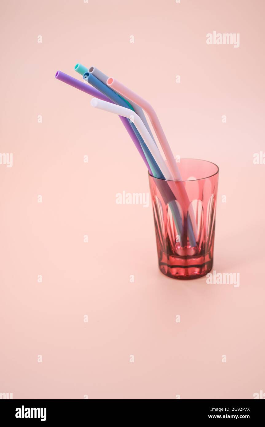Vertical shot of colorful reusable bend straws in a glass isolated on ...