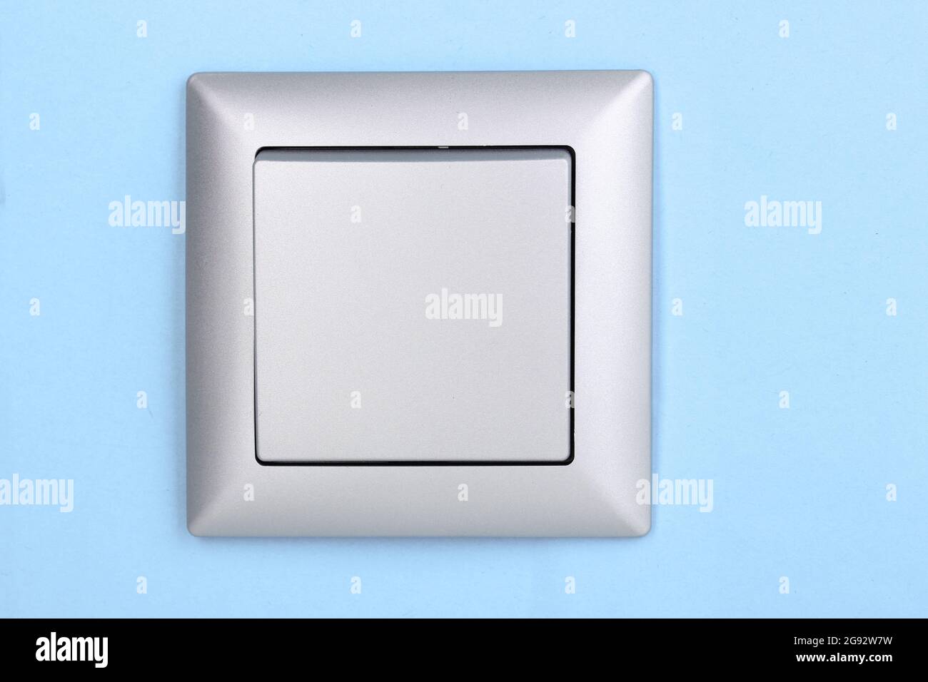 Modern light switch on blue background Stock Photo - Alamy
