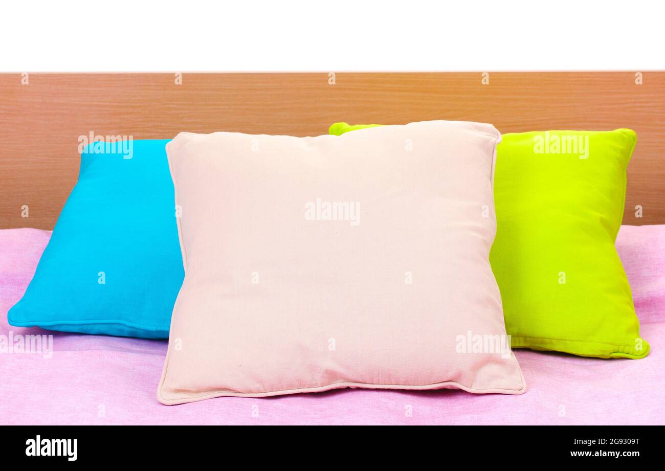 bright pillows on bed on white background Stock Photo - Alamy
