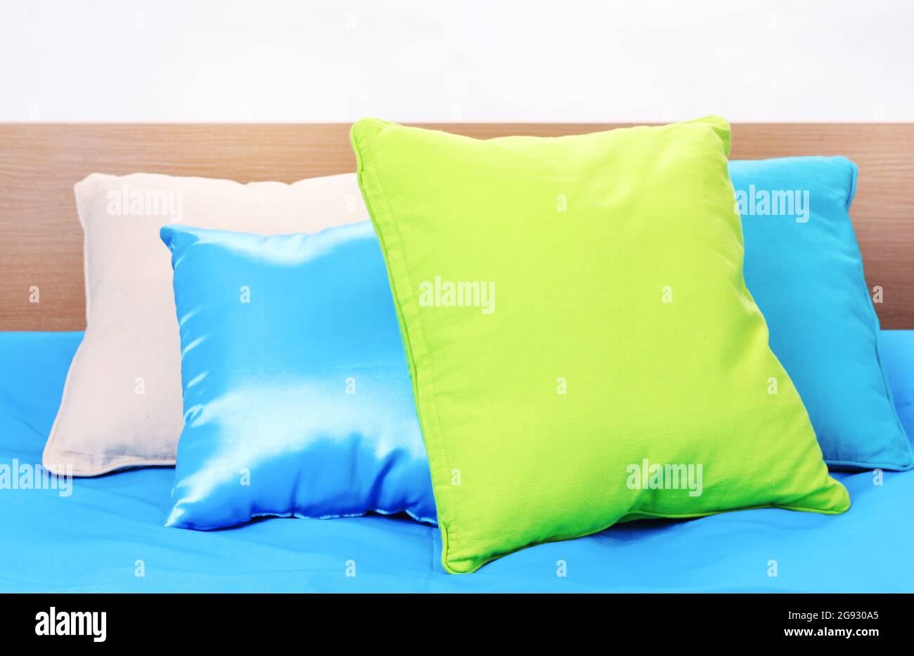 bright pillows on bed on white background Stock Photo - Alamy