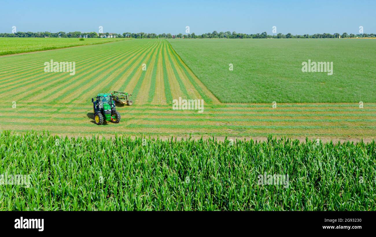 Above view, dolly move, on tractor as pulling grass cutting machinery ... Above view, dolly move, on tractor as pulling grass cutting machinery ...
