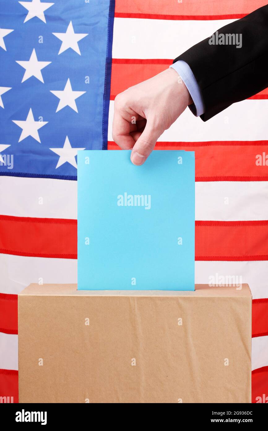 Hand with voting ballot and box on Flag of USA Stock Photo - Alamy