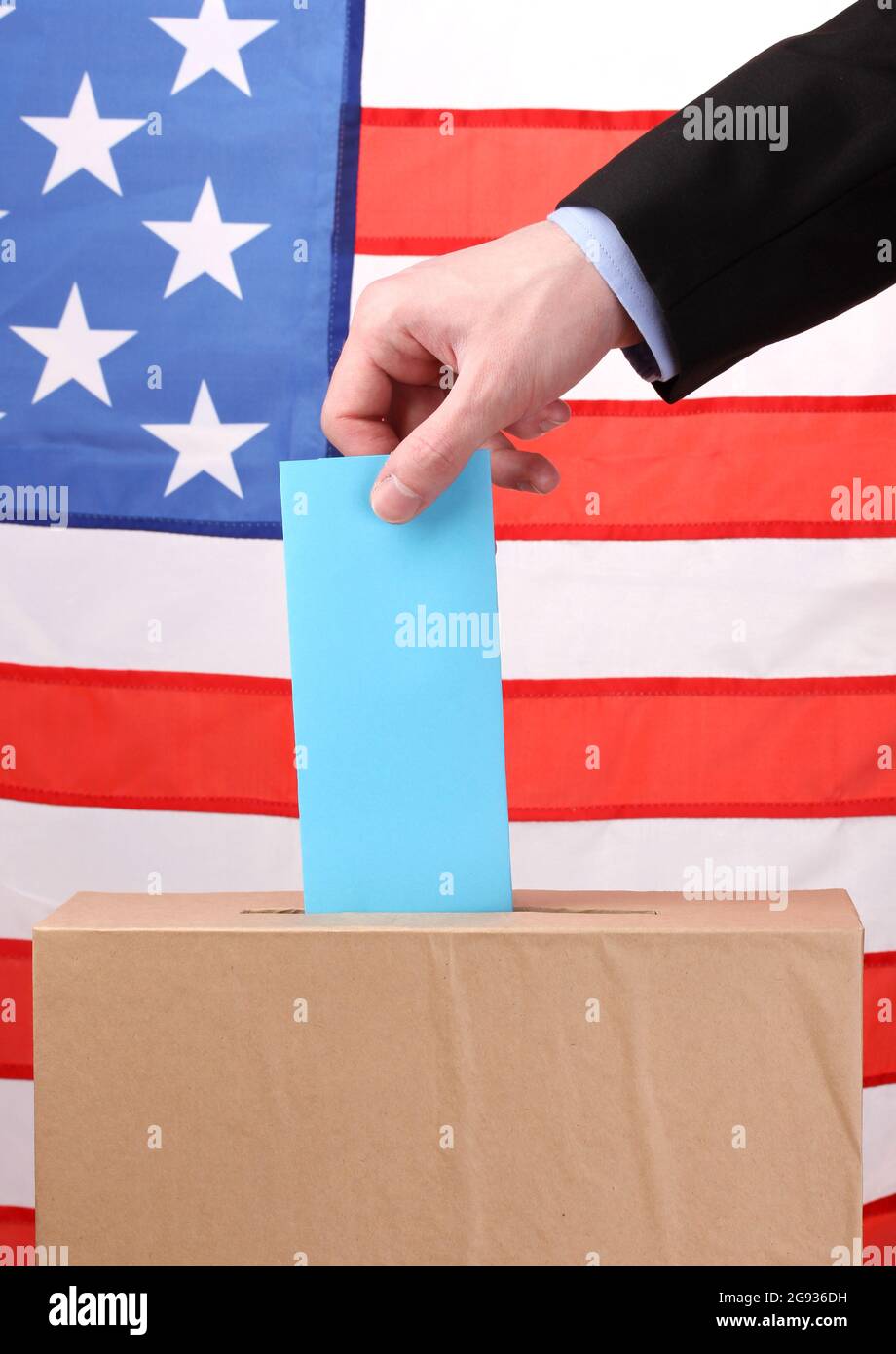 Hand with voting ballot and box on Flag of USA Stock Photo - Alamy