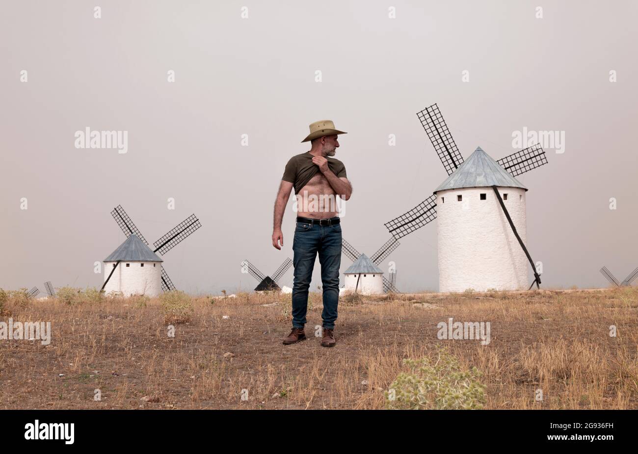 A man wearing a cowboy hat in the field with traditional white ...