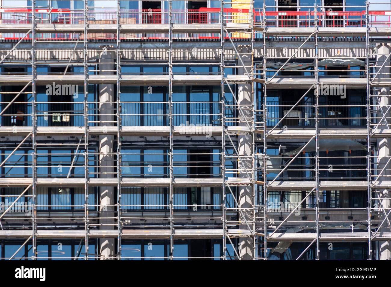 Scaffolding without workers placed on the facade of an office building ...