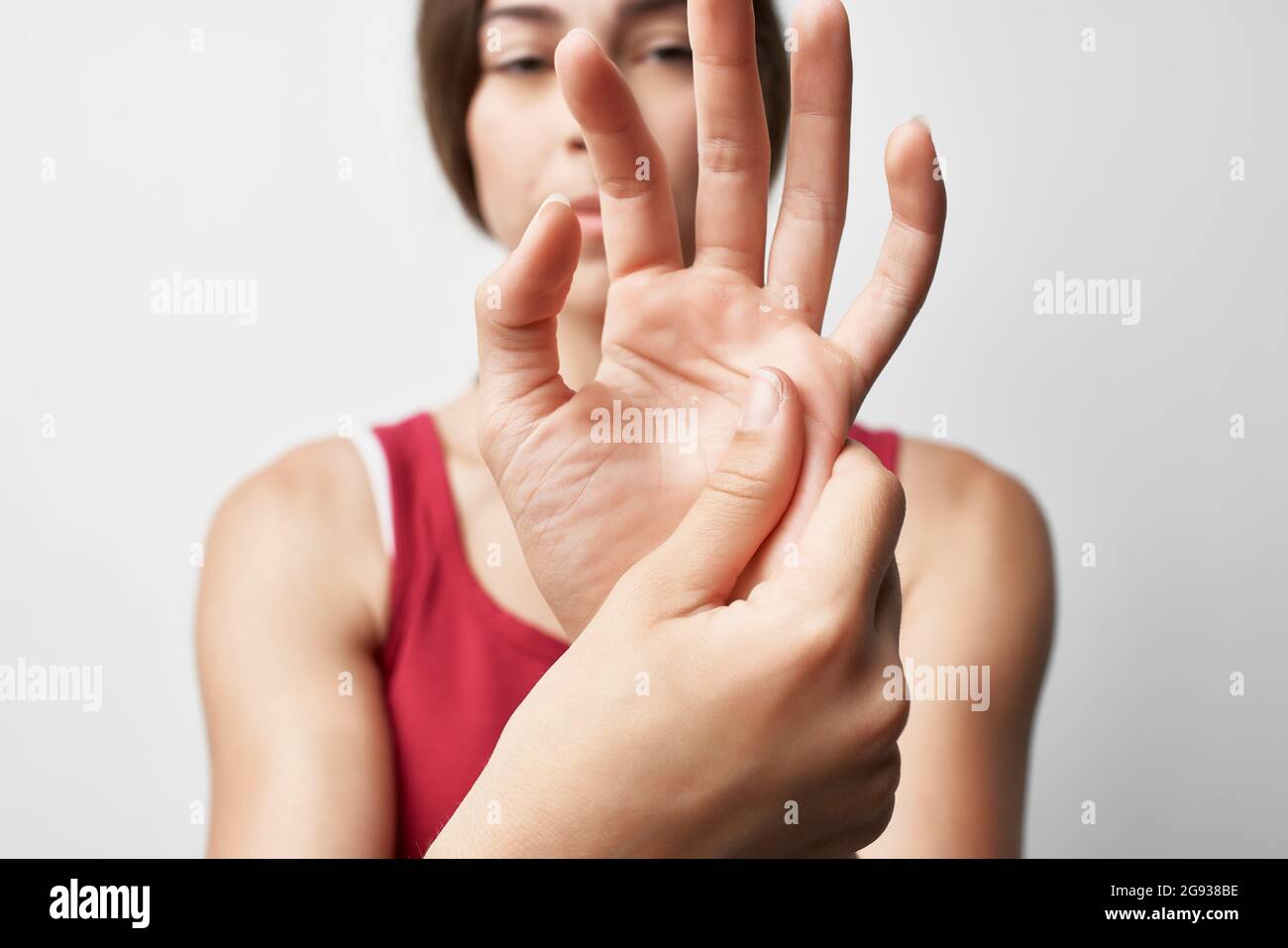 woman holding hand finger pain treatment medicine Stock Photo - Alamy