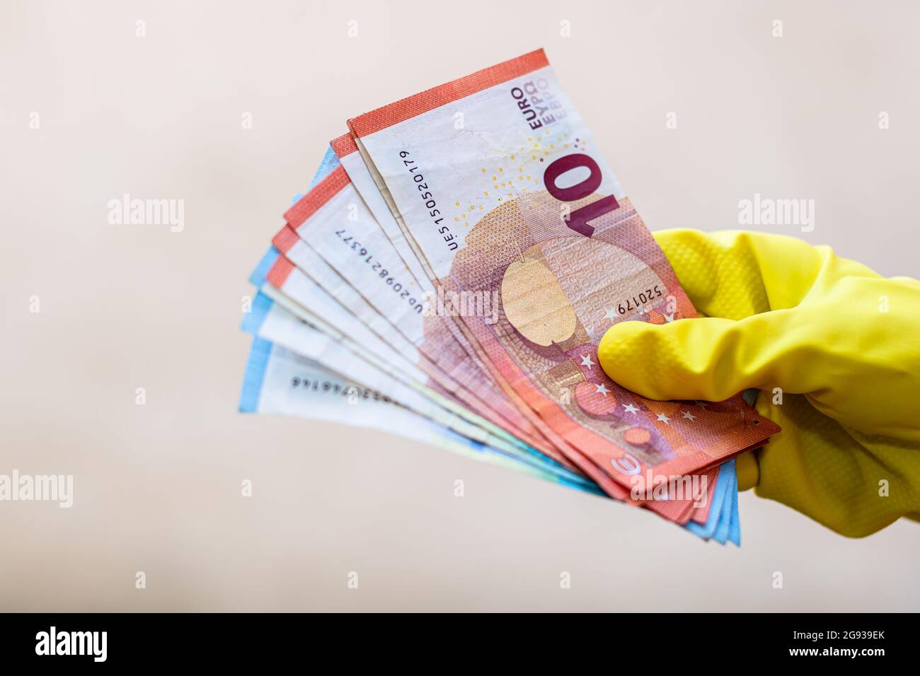 Hand with gloves receiving, giving or holding USD EURO banknote. World ...
