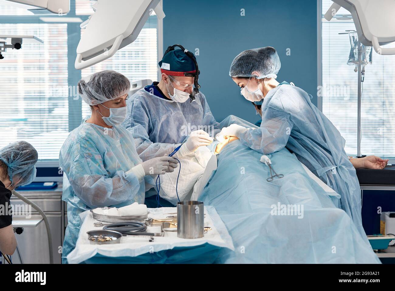 A team of women and men surgeons doing complex heart surgery ...