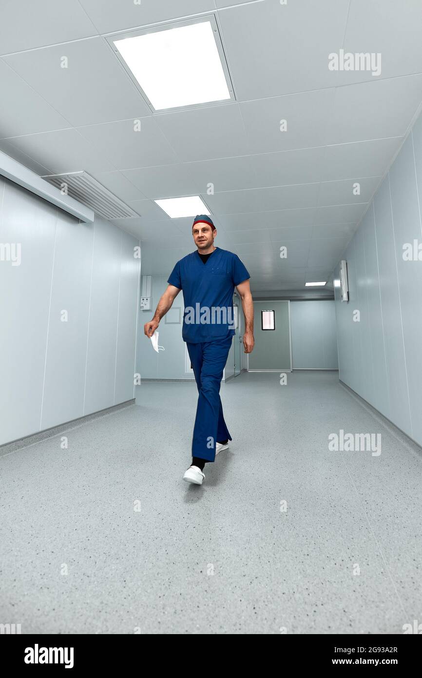 Male surgeon goes to the surgery in the clinic. Set up for major ...