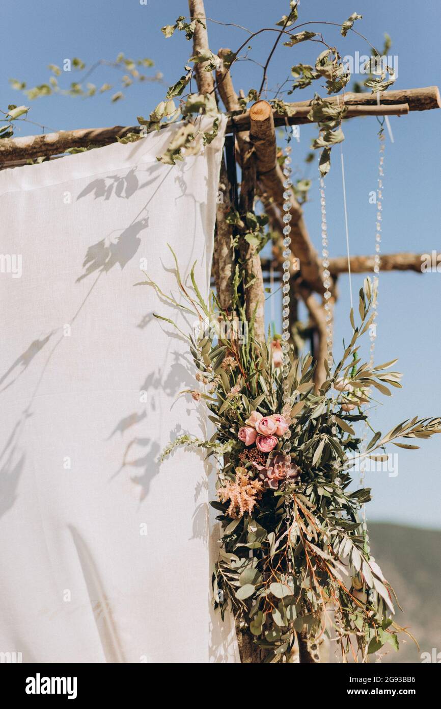 Fragment of a wedding arch for an exit ceremony decorated with flowers ...