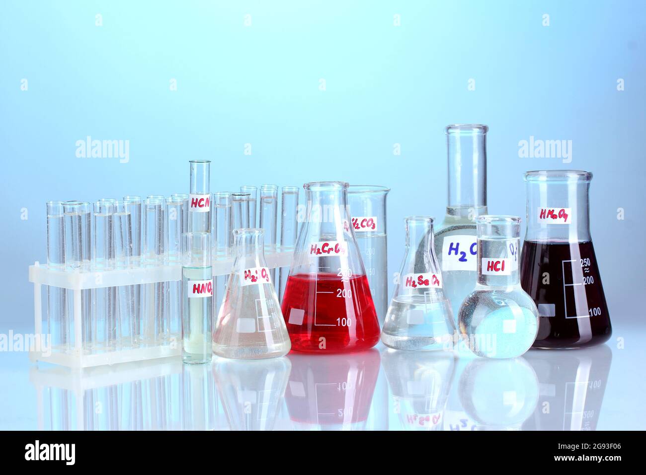 Test-tubes with various acids on blue background Stock Photo - Alamy