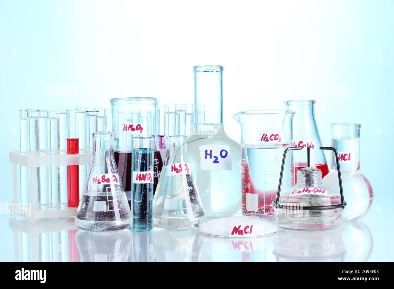 Test-tubes with various acids and chemicals on blue background Stock ...