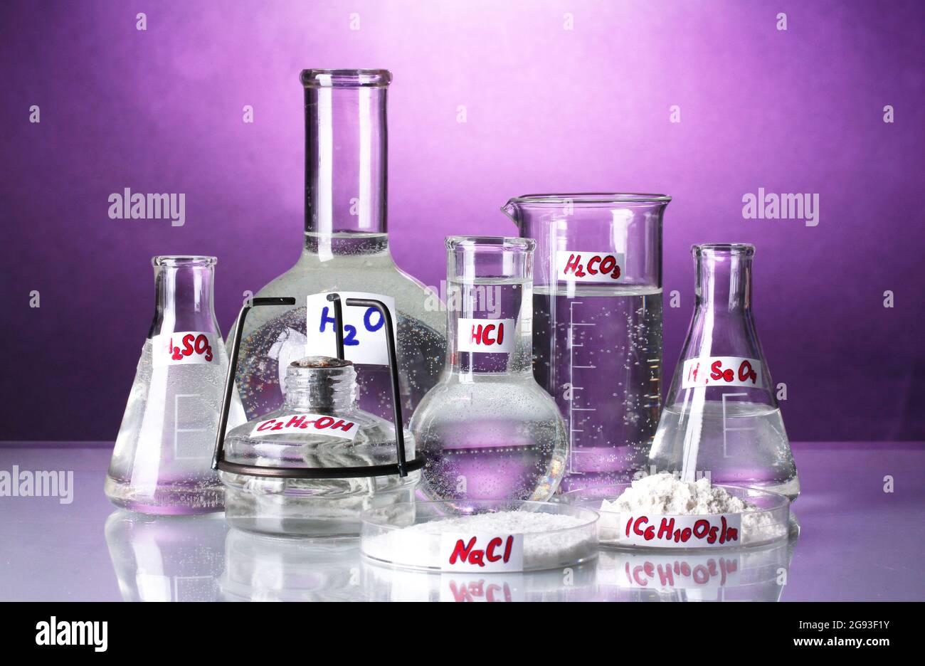 Test-tubes with various acids and chemicals on bright background Stock ...