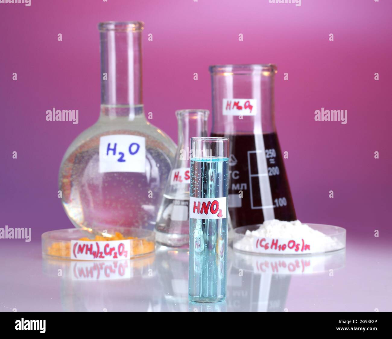 Test-tubes with various acids and chemicals on violet background Stock ...