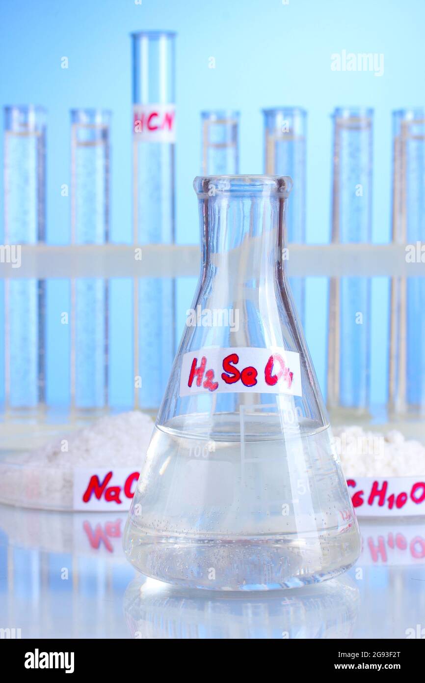 Test-tubes with various acids and chemicals on blue background Stock ...