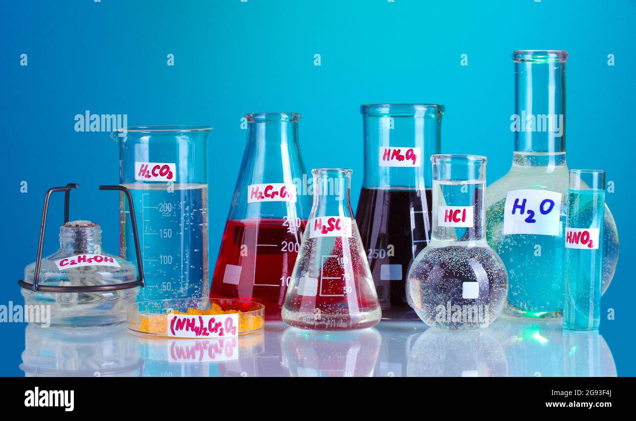 Test-tubes with various acids and chemicals on blue background Stock ...
