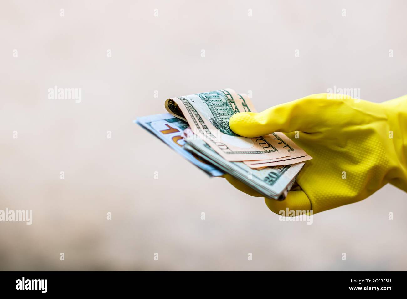 Hand with gloves receiving, giving or holding USD EURO banknote. World ...