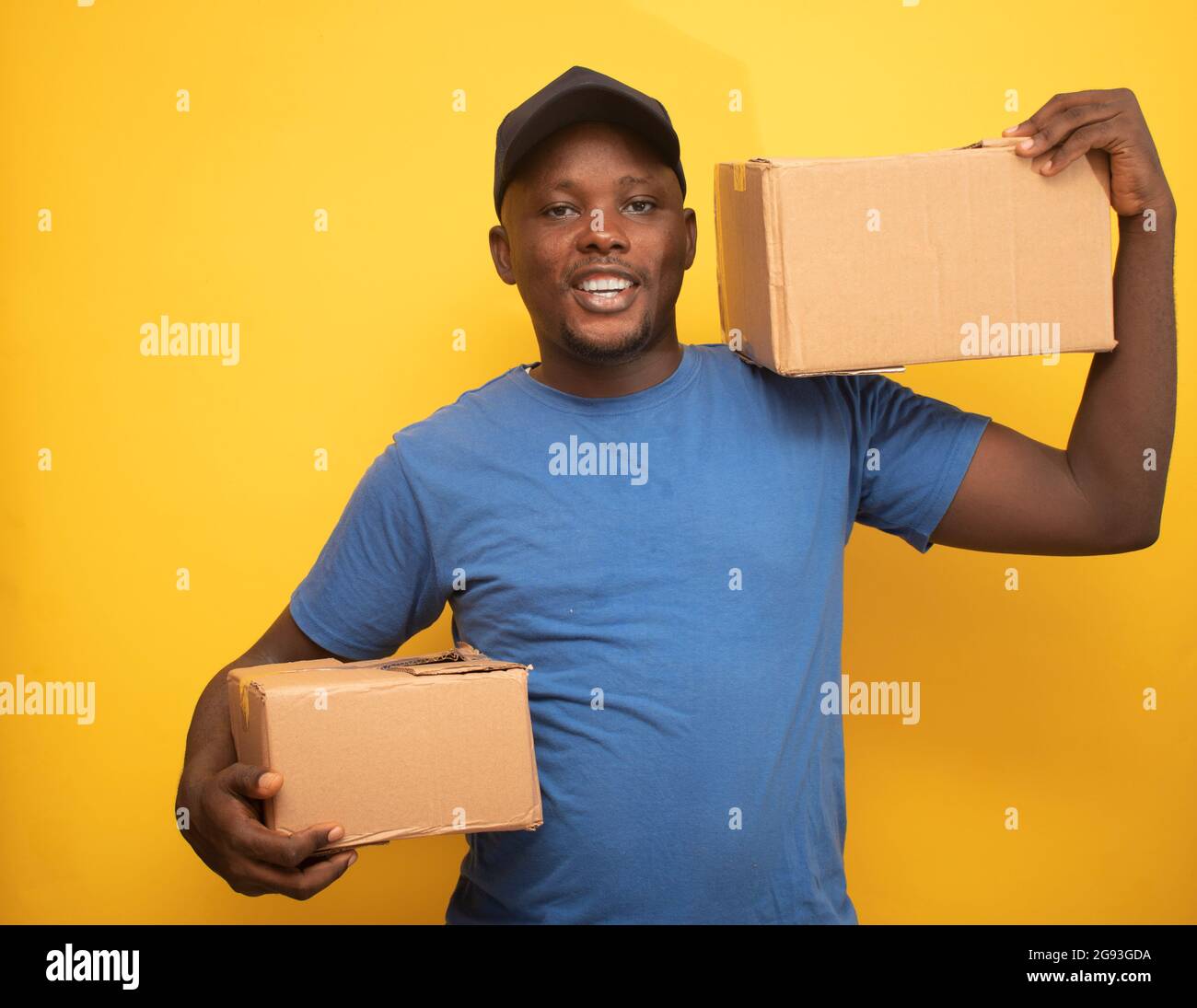 Black delivery man holding package hi-res stock photography and images ...
