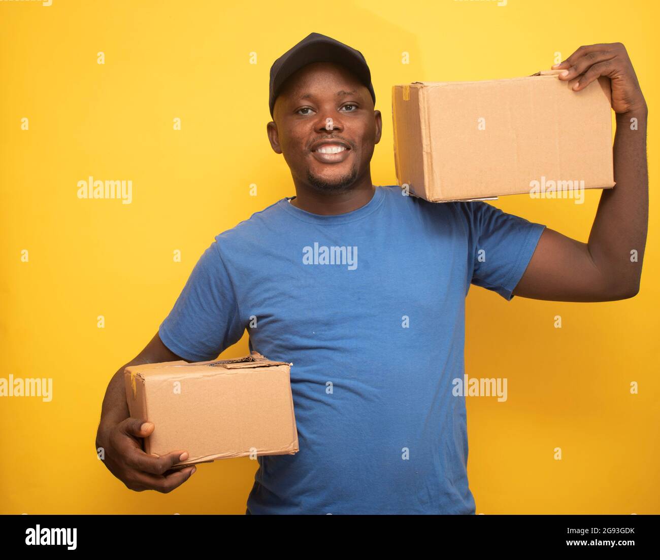 Black delivery man holding package hi-res stock photography and images ...