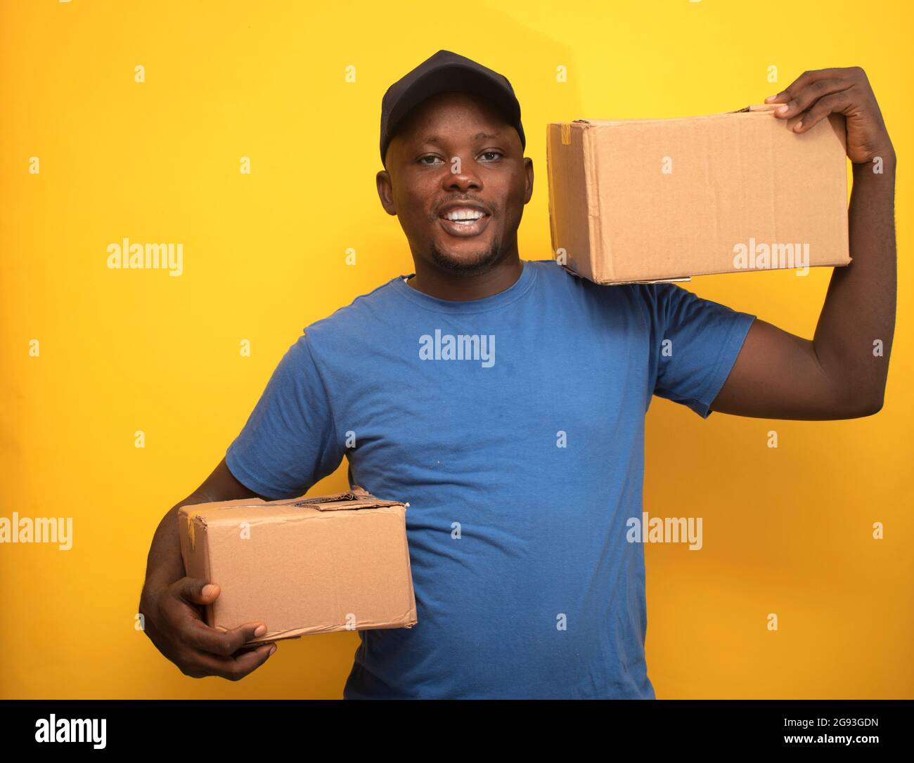 Black delivery man holding package hi-res stock photography and images ...
