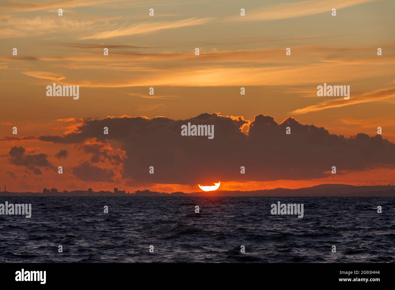 The sun about to set over the horizon Stock Photo - Alamy