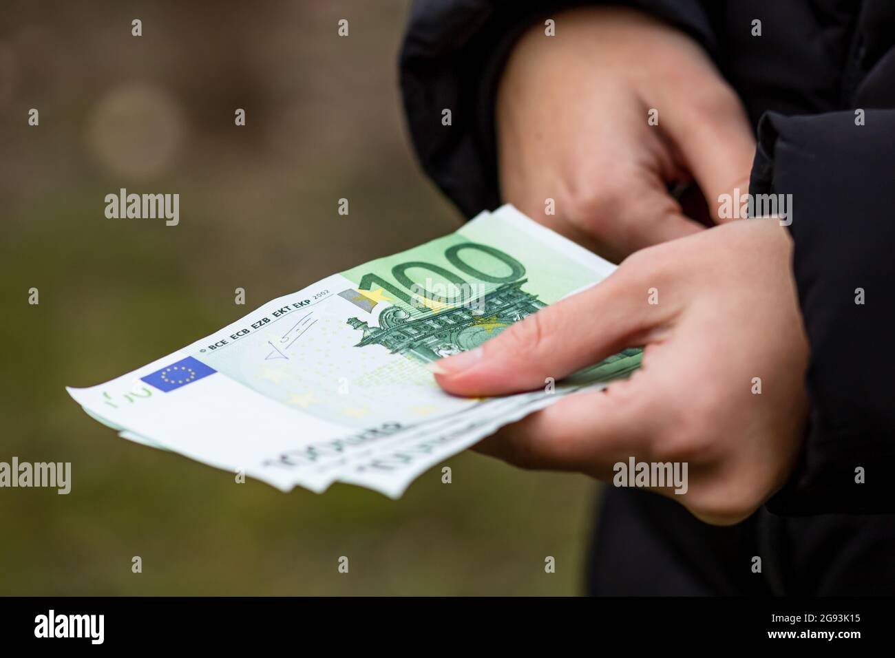 Selective focus on detail of EURO banknotes. Counting or giving EURO ...