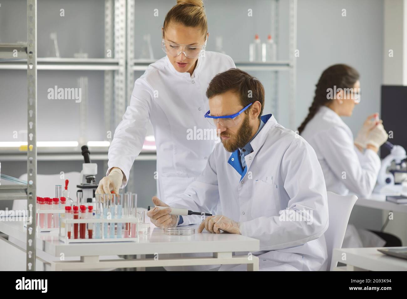 Group of serious scientists working in a pharma or biotech scientific ...