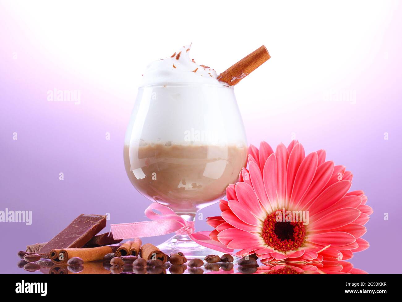 glass of coffee cocktail and gerbera flower on purple background Stock ...