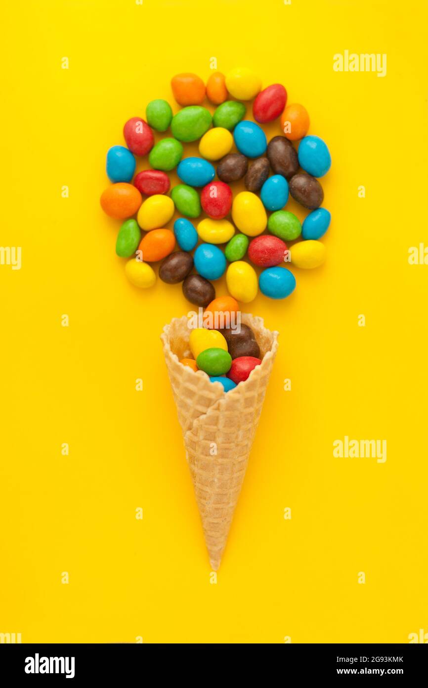 splash of colorful nuts or candies from ice cone. Explosion of dates ...