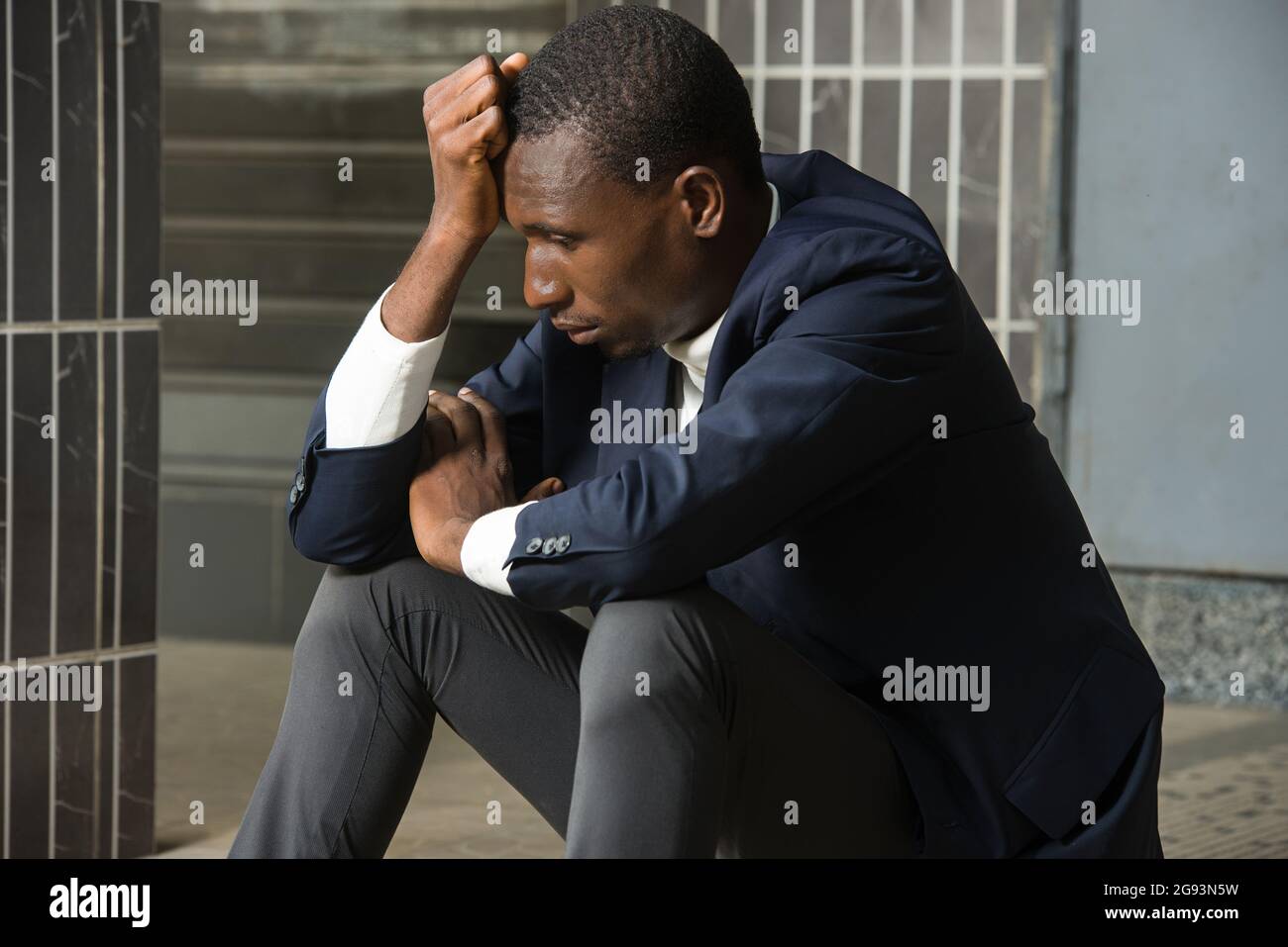 young man in suit sitting out depressed sad crying devastated feeling ...
